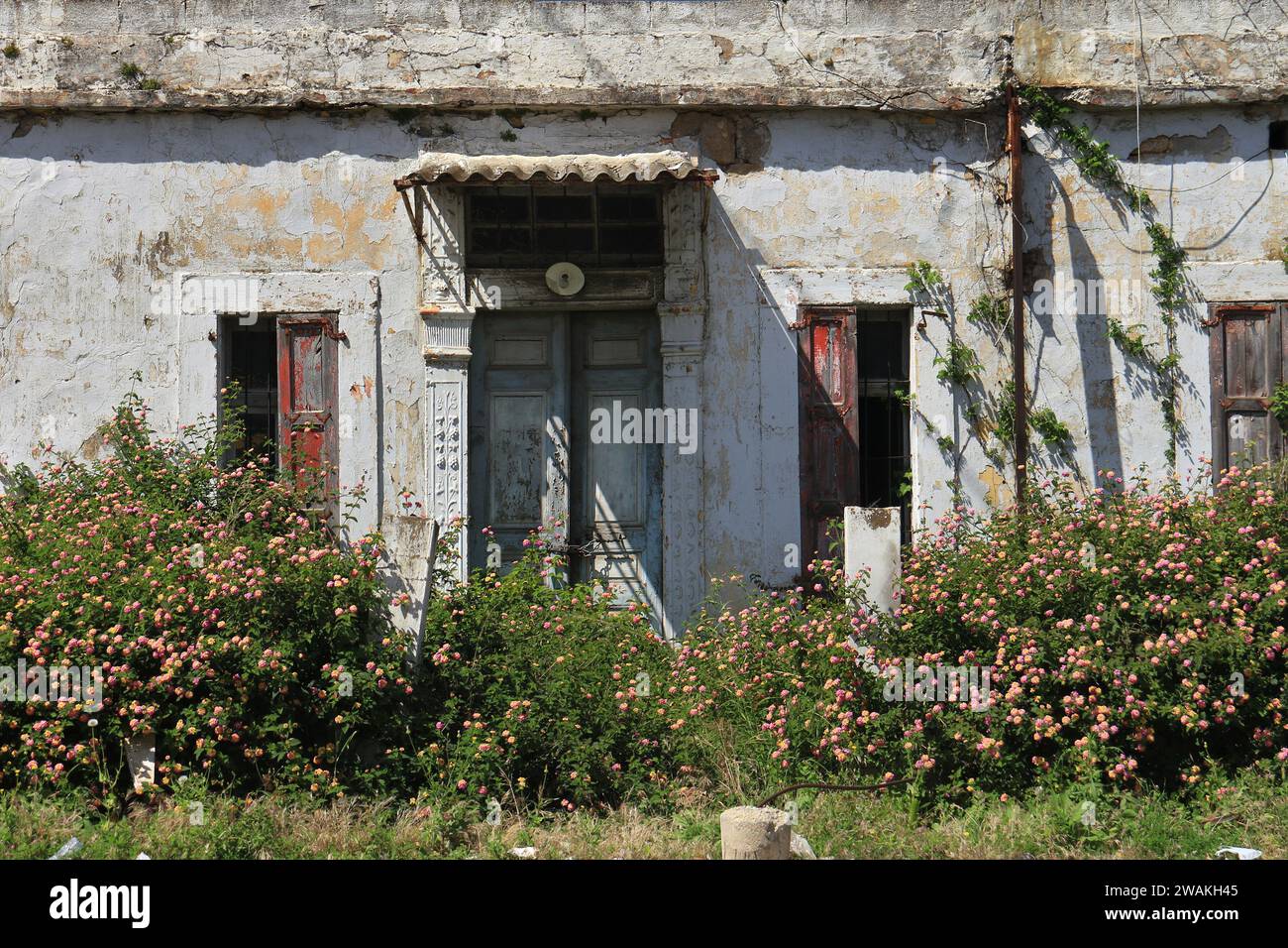 A house facade with weathered windows and door in the coastal city of ...