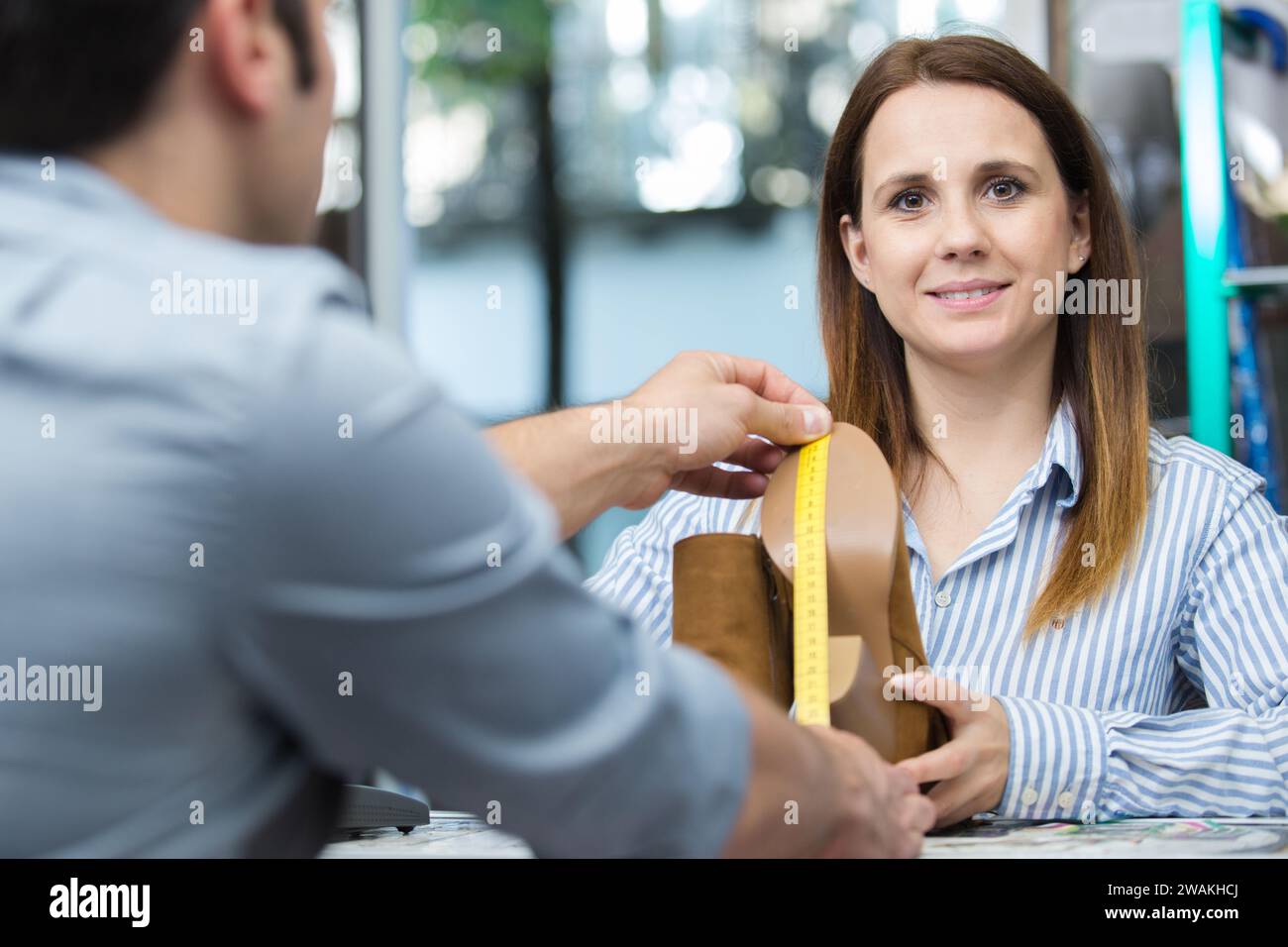 portrait of female customer at cobblers counter Stock Photo - Alamy