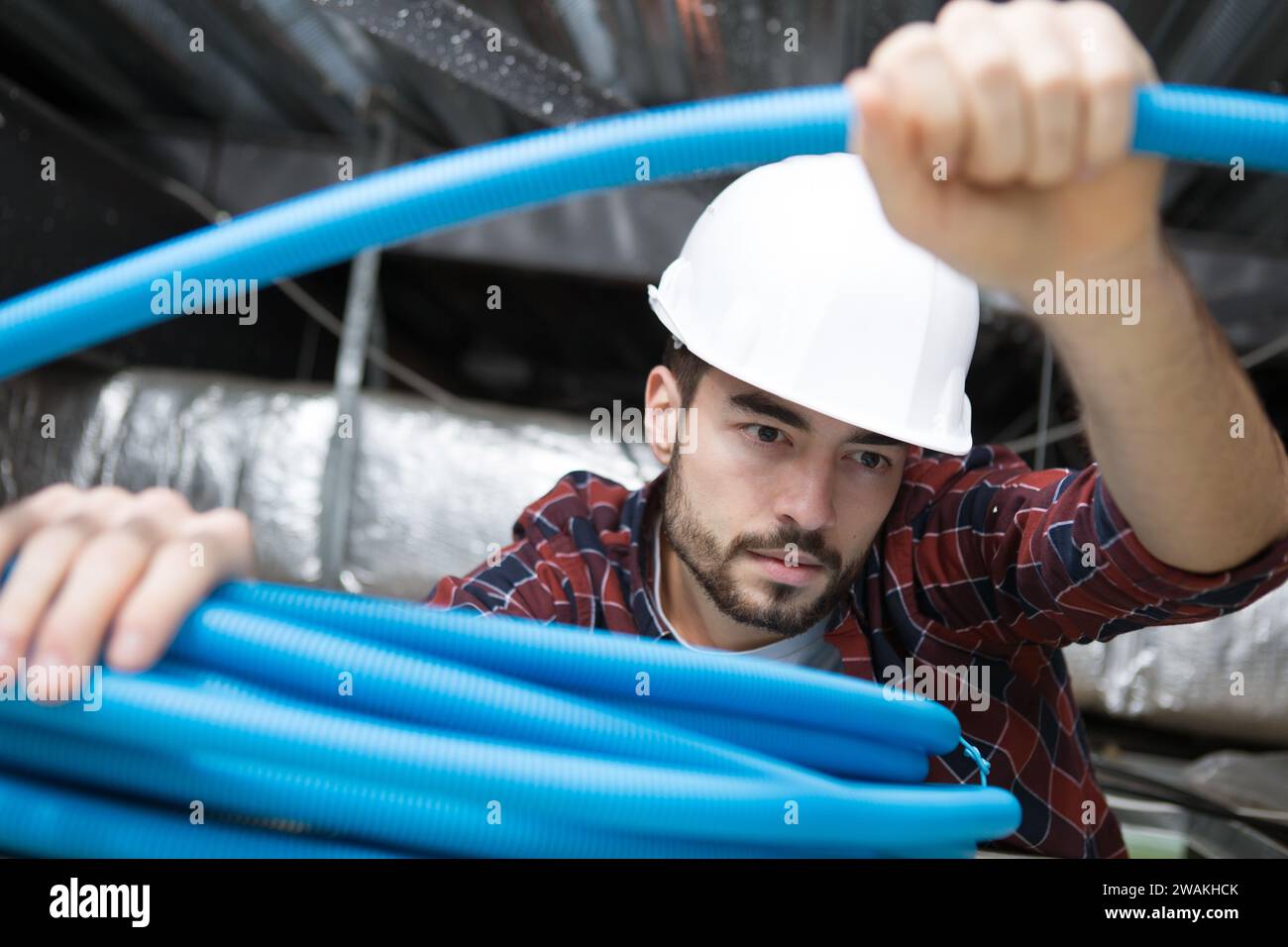 electrical worker wiring in ceiling Stock Photo - Alamy
