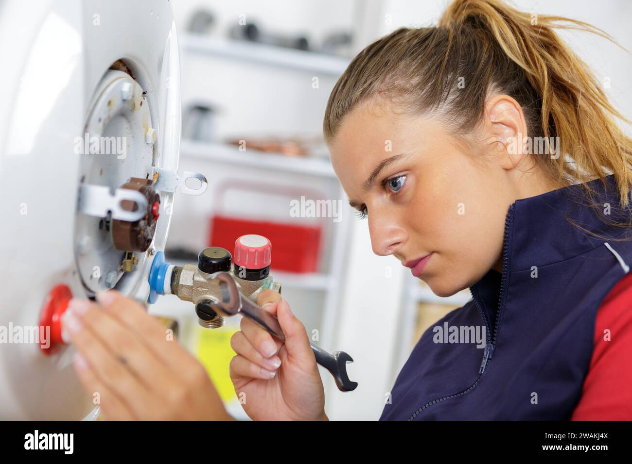 Young woman repairing servicing hi-res stock photography and images - Alamy