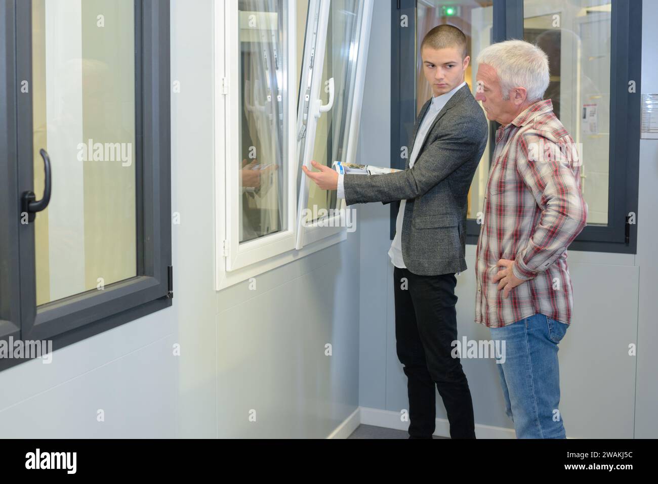 adult male seller demonstrating window Stock Photo - Alamy