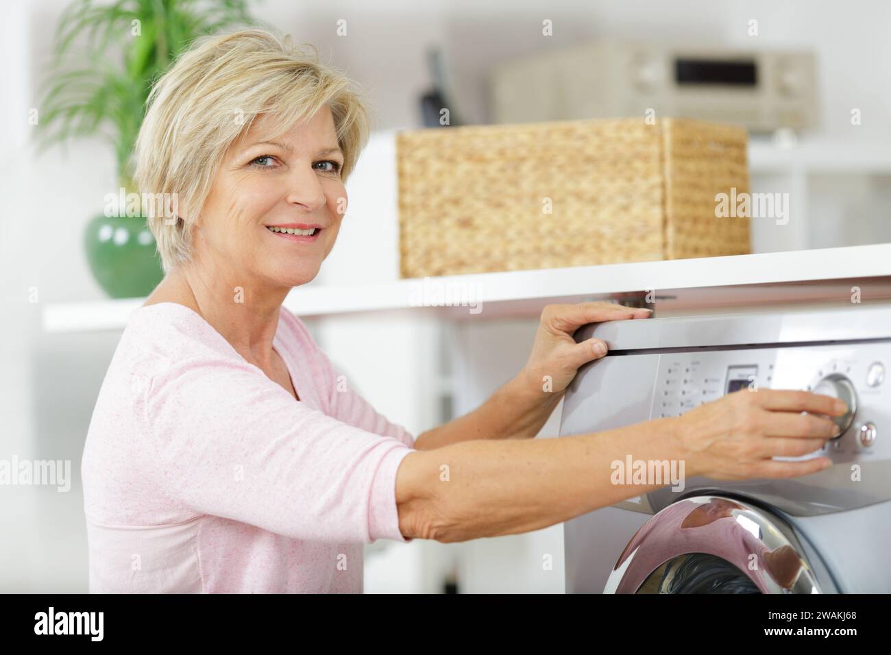 Mature woman washing machine hi-res stock photography and images - Alamy