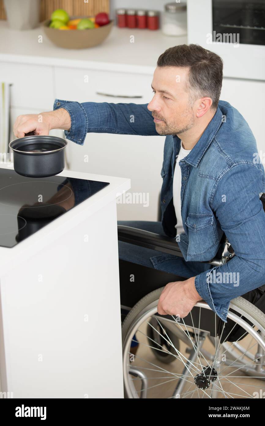 disabled man in wheelchair in the kitchen Stock Photo - Alamy