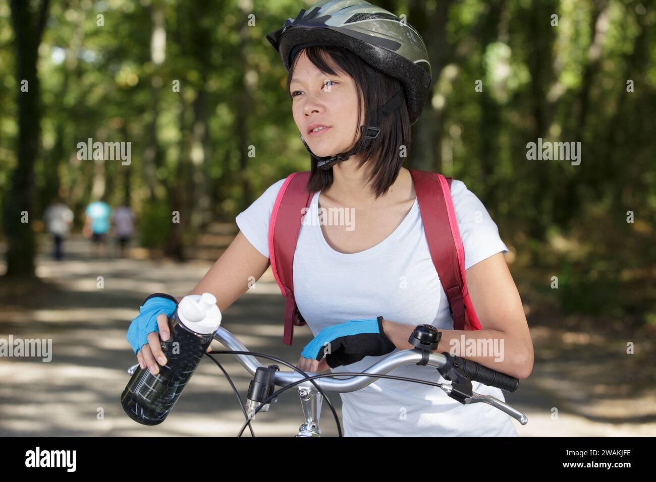 Young woman bicyclist in helmet hi-res stock photography and images - Alamy