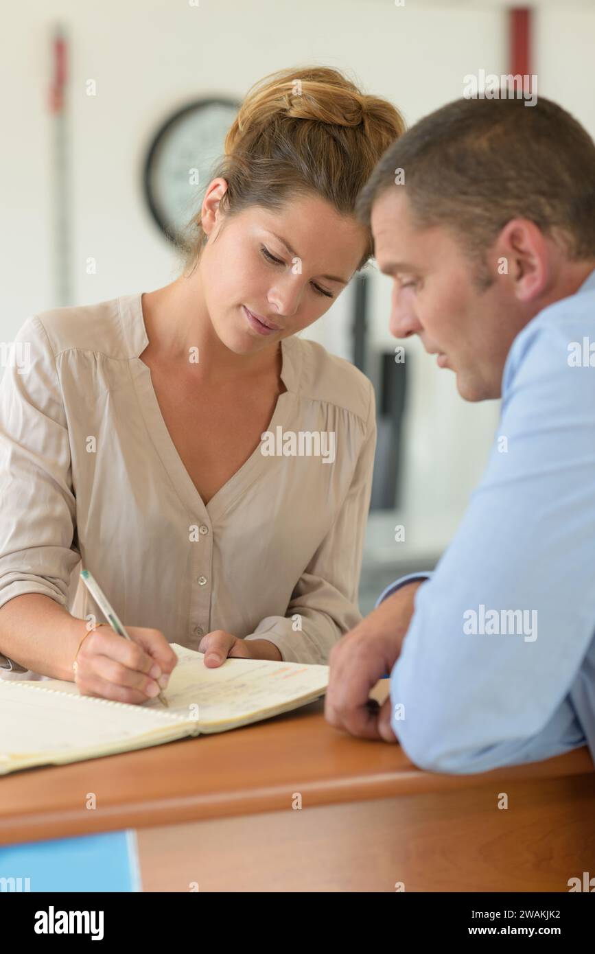 couple is signing a book Stock Photo - Alamy
