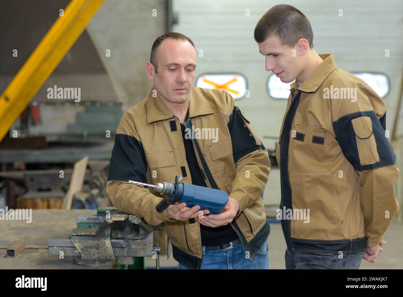 Tradesman showing apprentice drill hi-res stock photography and images ...