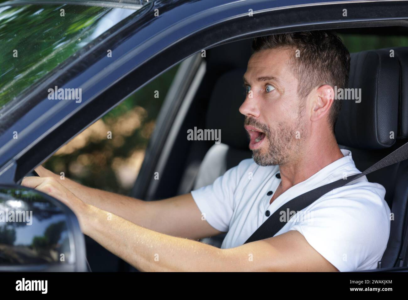 Shocked businessman driving car hi-res stock photography and images - Alamy