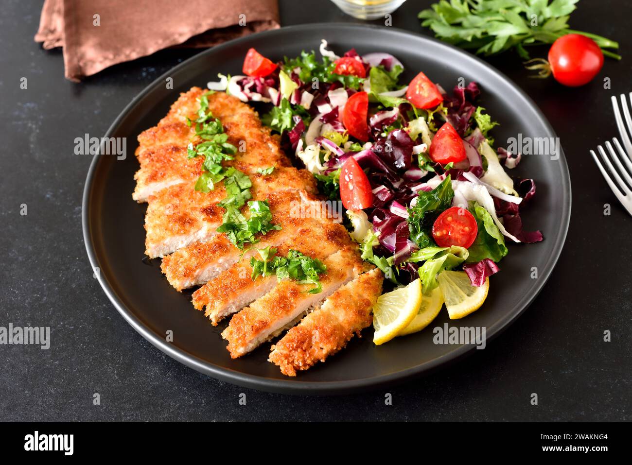 Chicken schnitzel and vegetable salad on plate Stock Photo - Alamy