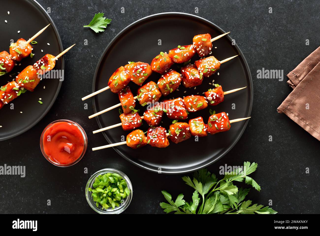 Teriyaki chicken skewers on plate over black background. Top view, flat lay Stock Photo - Alamy