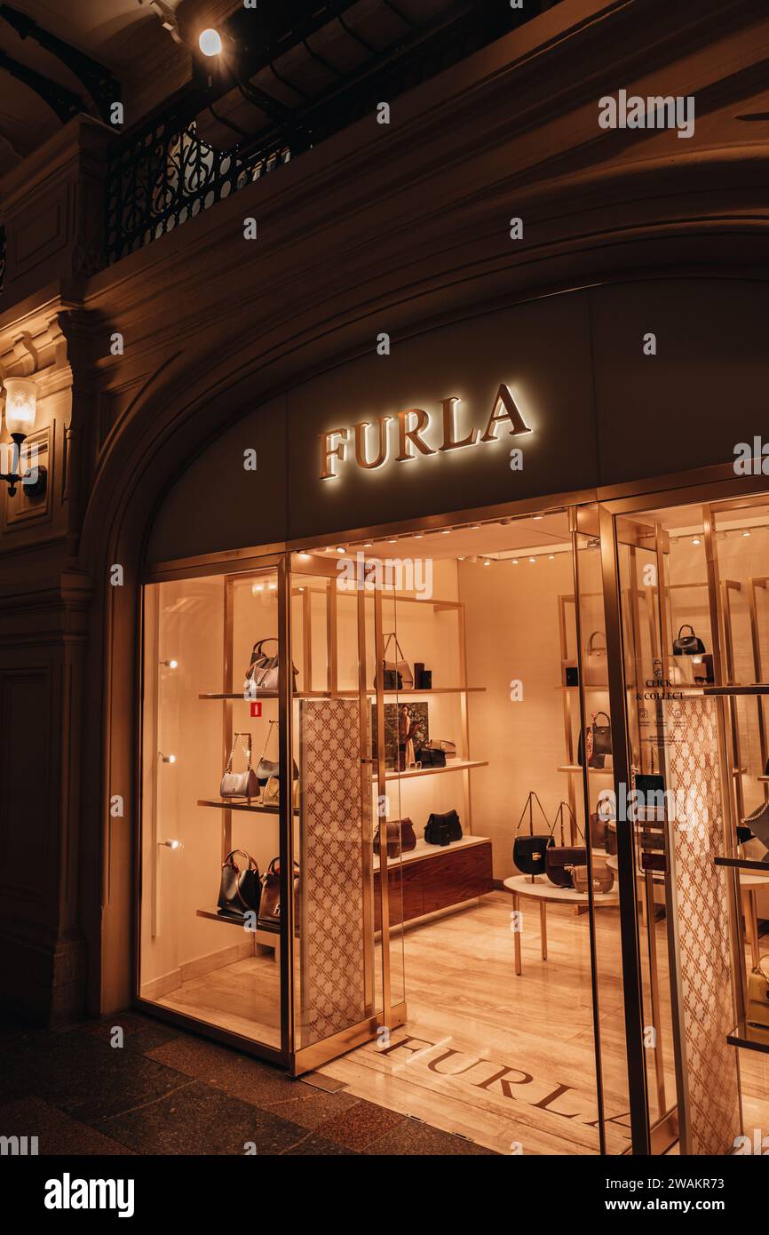 Famous brand Furla retail shop golden logo signboard on the storefront ...