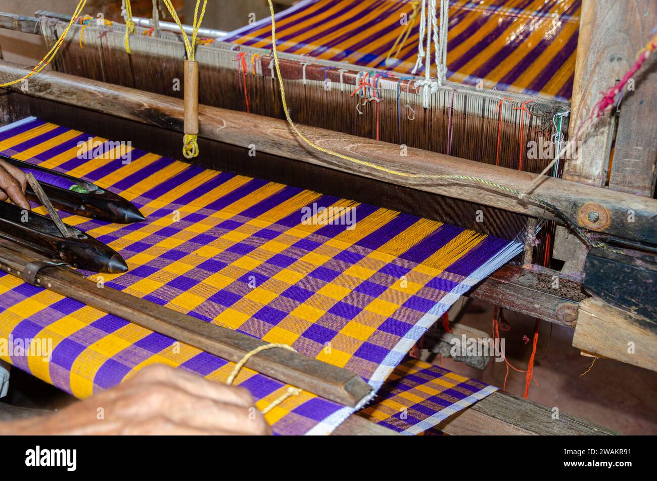 Cotton weaving on a traditional wooden handloom Stock Photo - Alamy