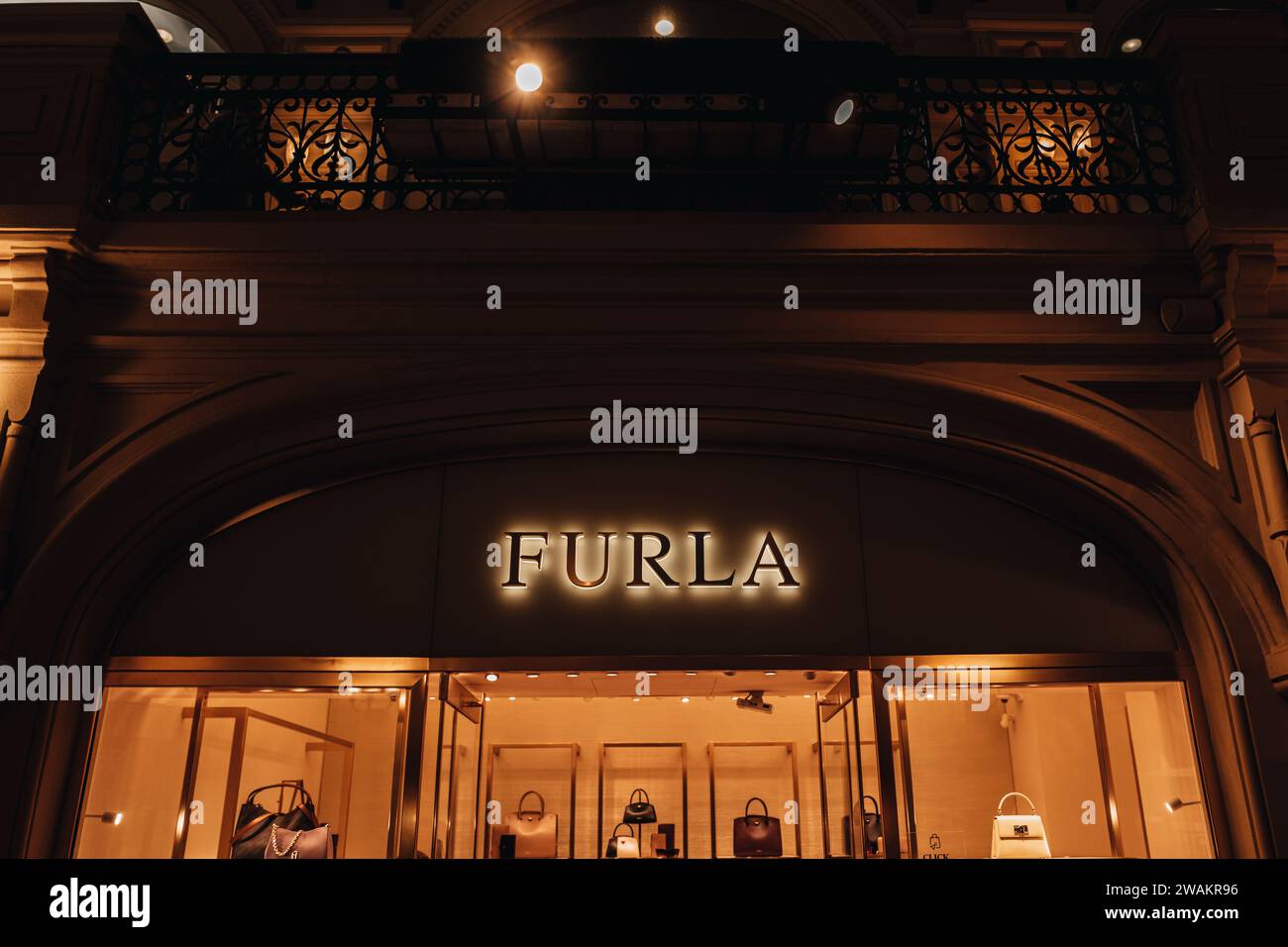 Famous brand Furla retail shop golden logo signboard on the storefront ...