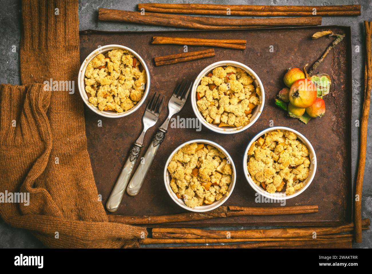 Apple crumble in small molds on a rusty tray, top view Stock Photo - Alamy