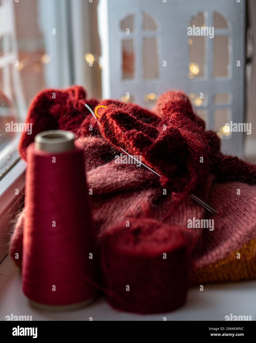 photo with unfinished knitted work, needlework concept, homemaker's ...