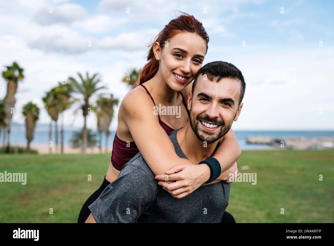 Affectionate young handsome happy fitness couple looking each other ...