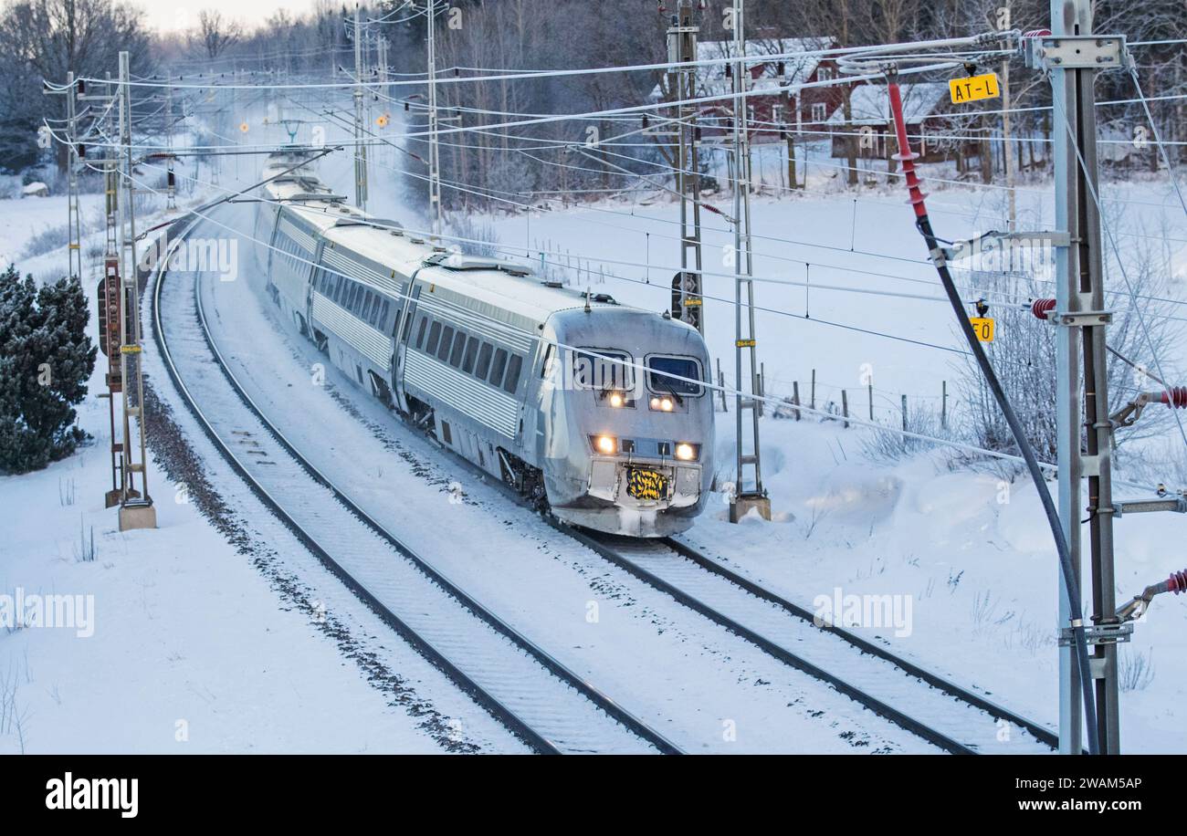 Seasonal weather, a X2000 train from SJ, just south Mjölby, Sweden ...