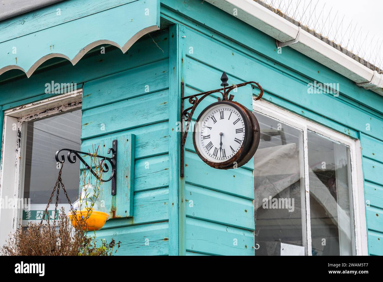 Clock hanging on building hi-res stock photography and images - Alamy