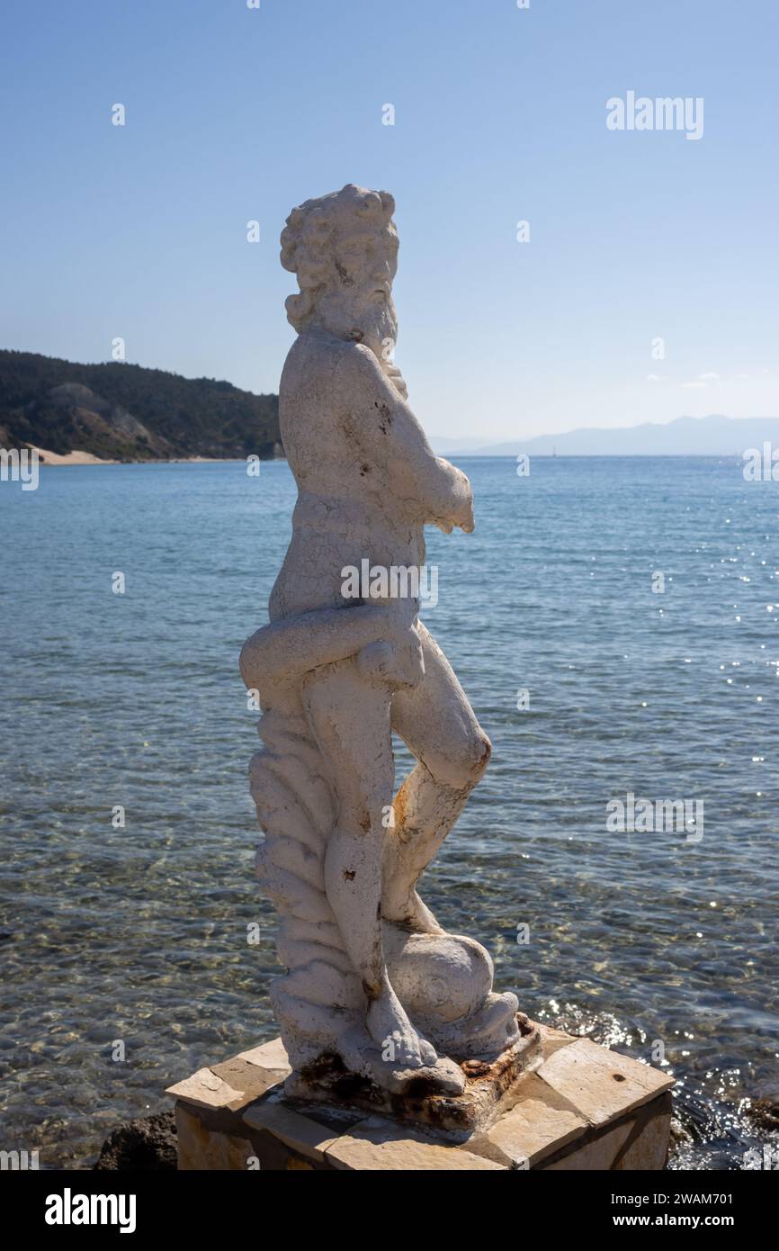 Calm and clean Ionian sea. Statue of Nereus in the harbor. Glittering ...