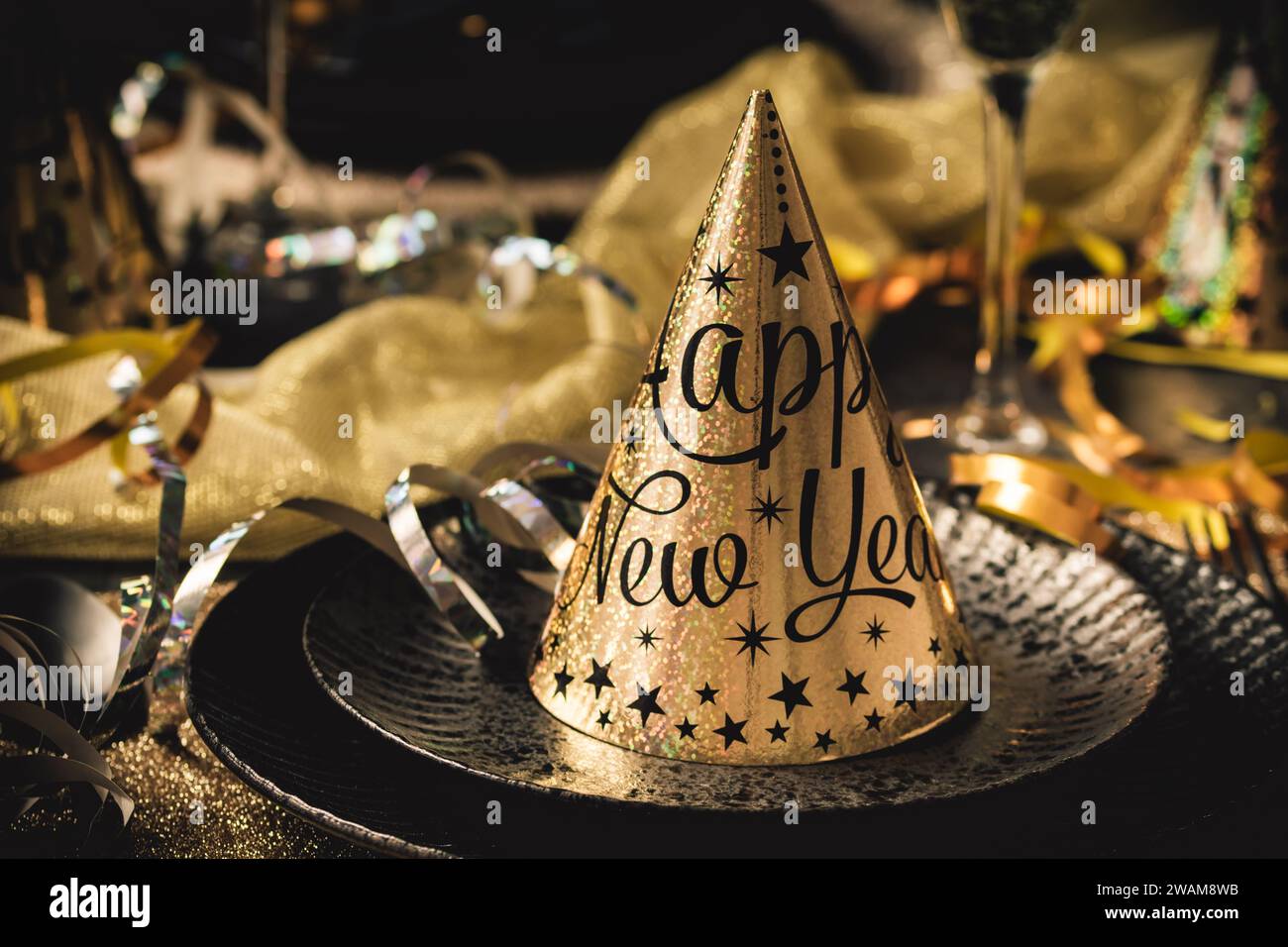 Table decorated for New Year party with golden and black colors, two ...