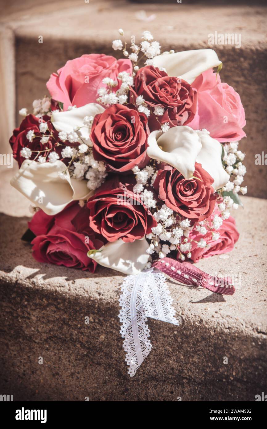 Bridal bouquet with red, pink and white roses, white callas and ...