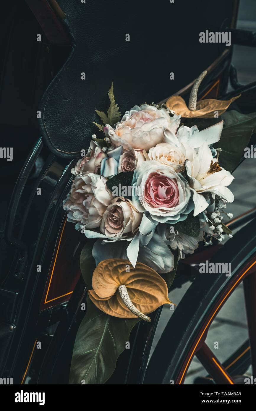 Artificial flower arrangement on a carriage with roses, peonies and ...