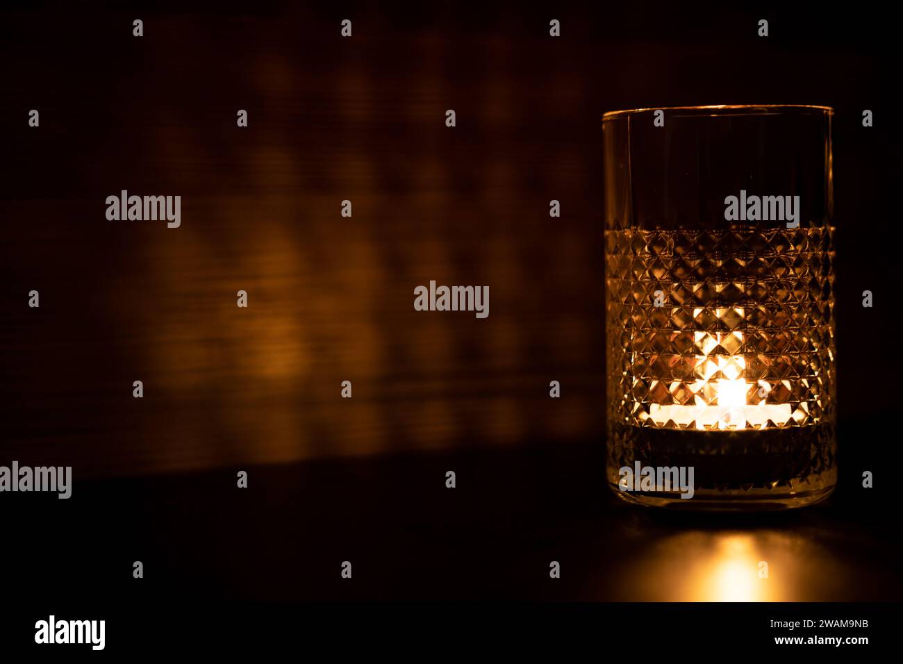 Candle in a glass. Rays of light are refracted through the walls of the ...