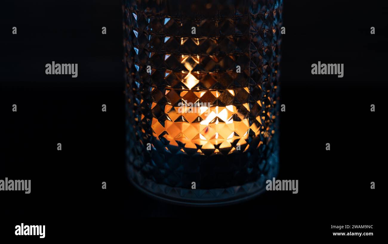 Candle in a glass. Rays of light are refracted through the walls of the ...