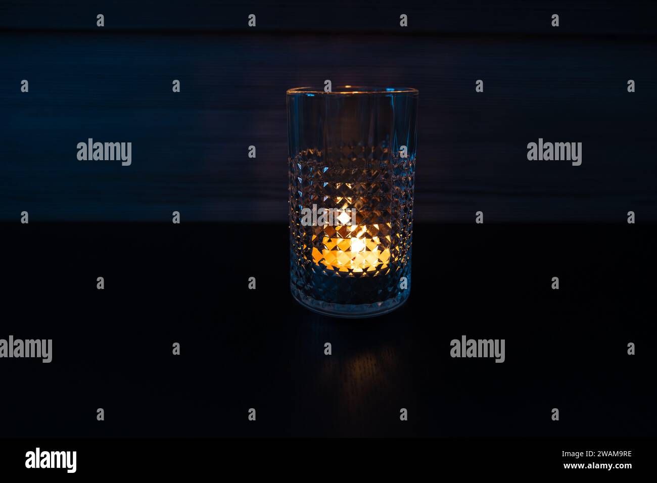 Candle in a glass. Rays of light are refracted through the walls of the ...
