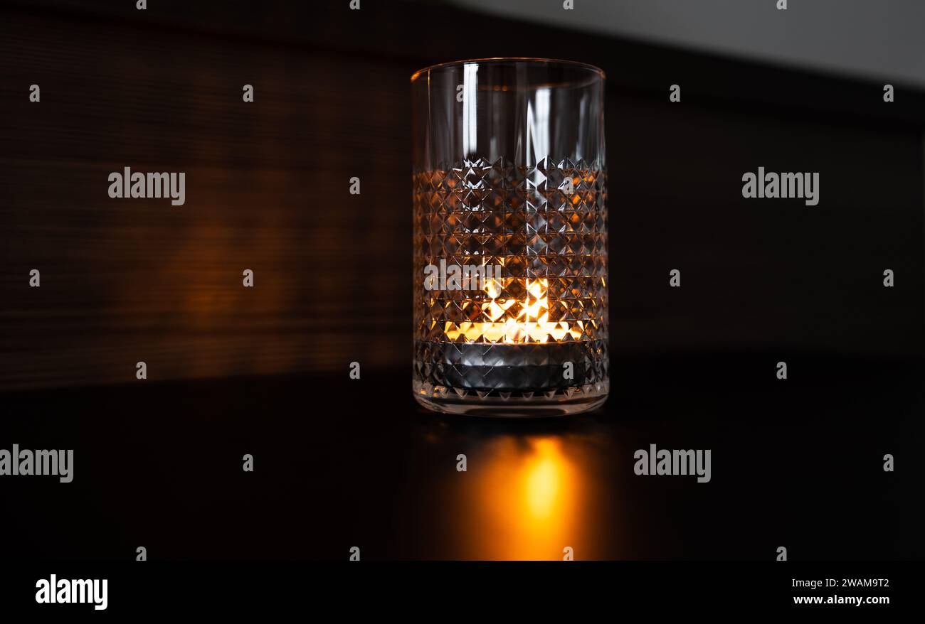 Candle in a glass. Rays of light are refracted through the walls of the ...