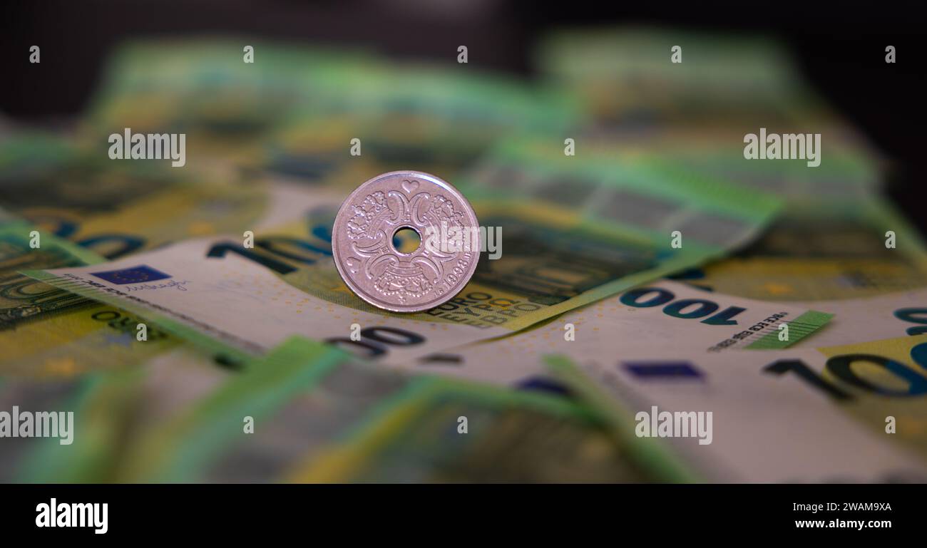 Danish krone, coin and banknotes. One Krone Coin on a one hundred Euro ...