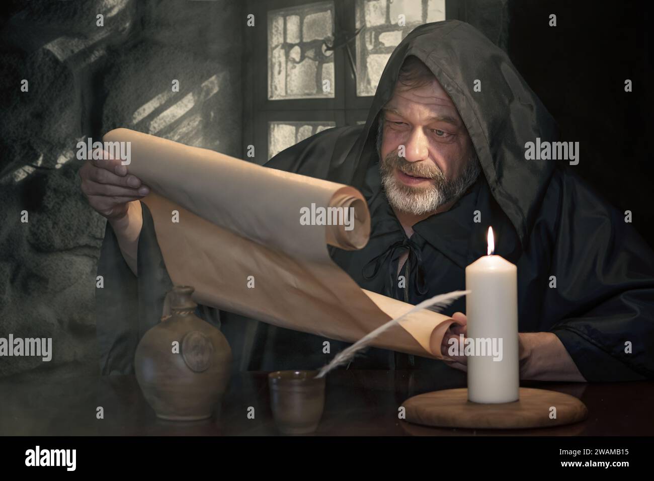 Emotional portrait of an elderly monk, by candlelight reading a message ...
