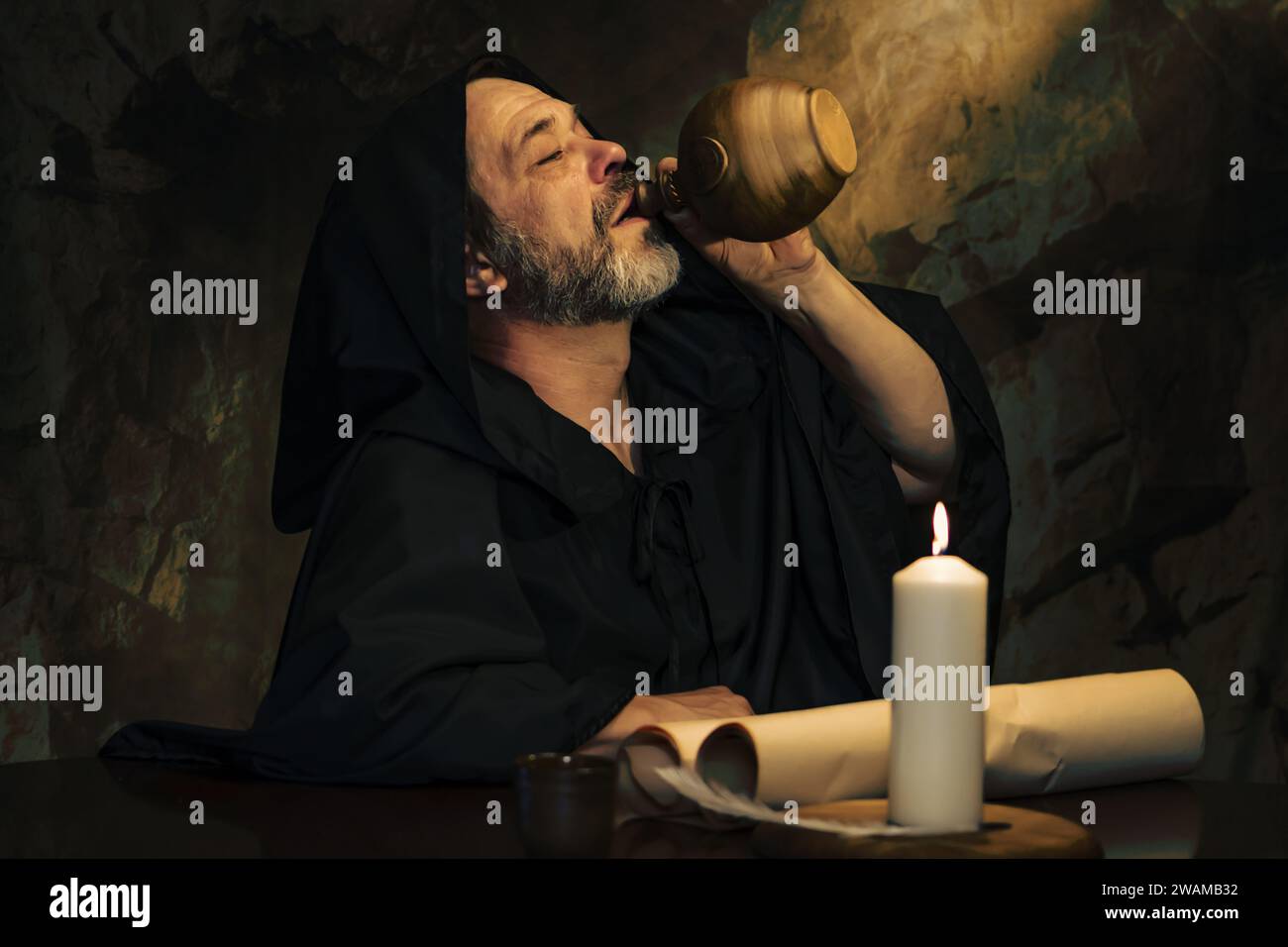 An elderly monk drinking from a clay jug, a dark and smoky stone cell ...