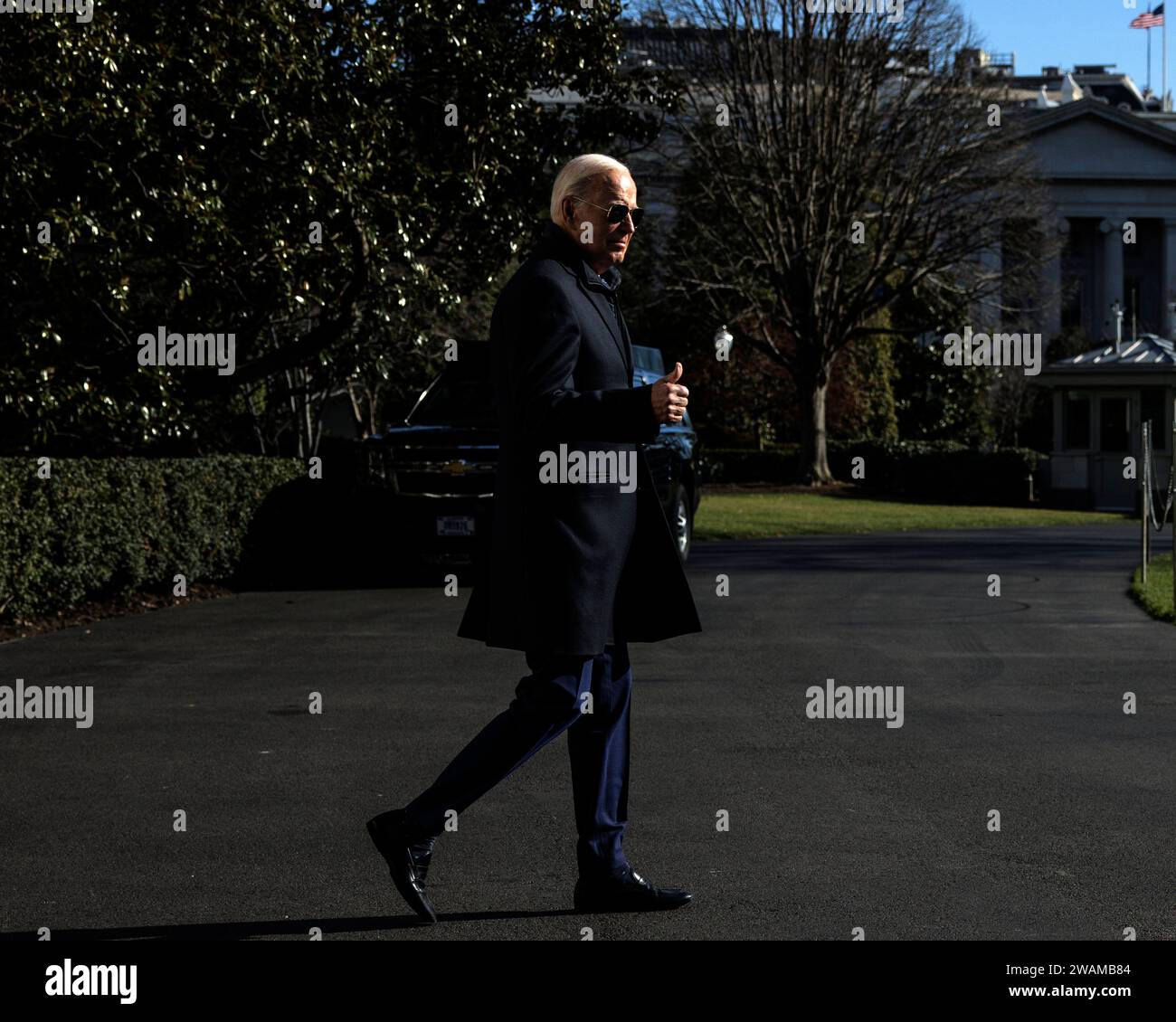 United States President Joe Biden gives a thumbs up as he walks out of ...