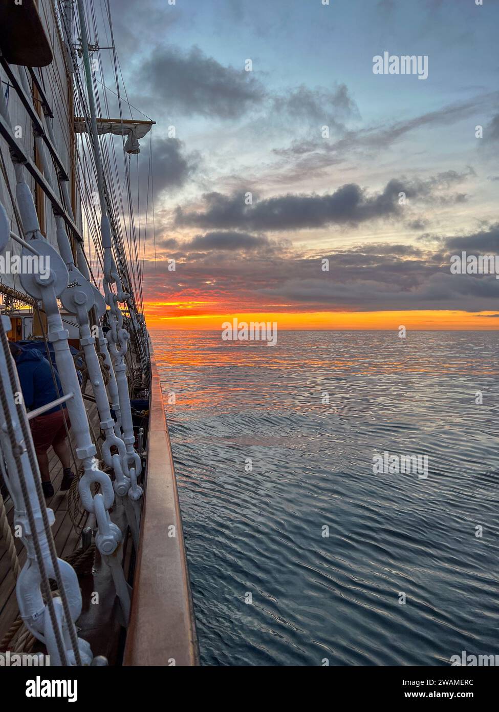 Orange sunrise over the Atlantic Ocean seen from a tall ship bow Stock ...