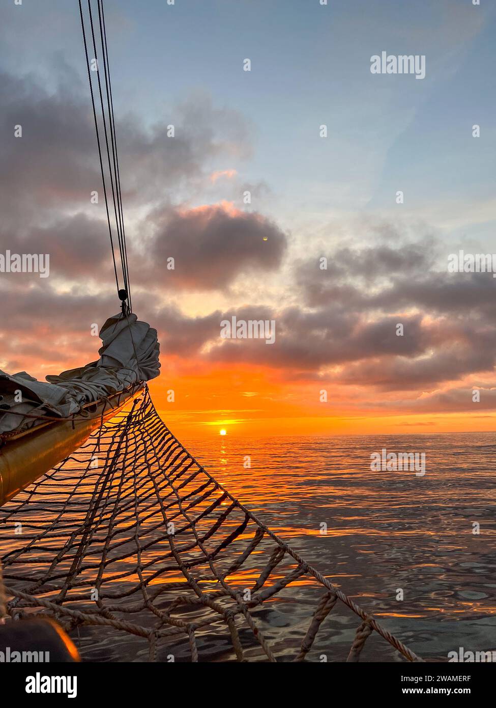 Orange sunrise over the Atlantic Ocean seen from a tall ship bow Stock ...