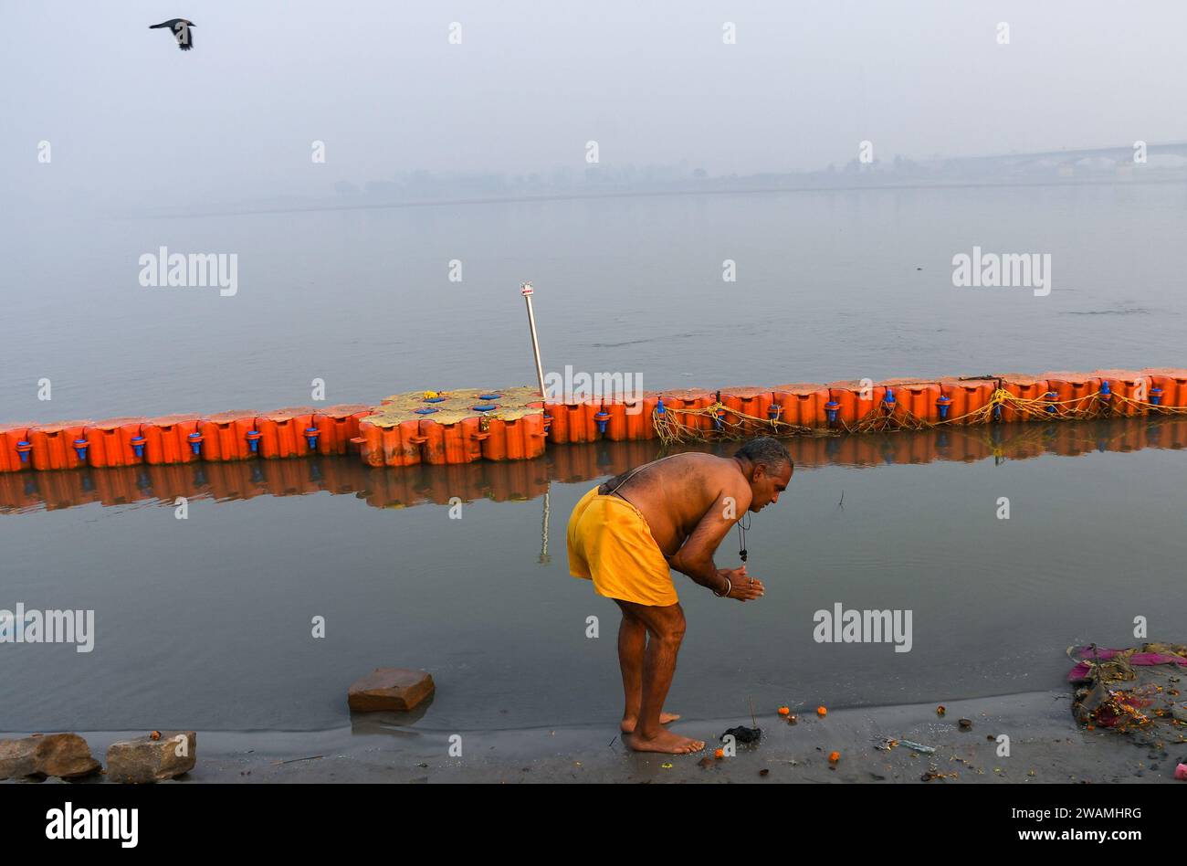 A Hindu devotee offers his prayers on the banks of Sarayu river. The ...