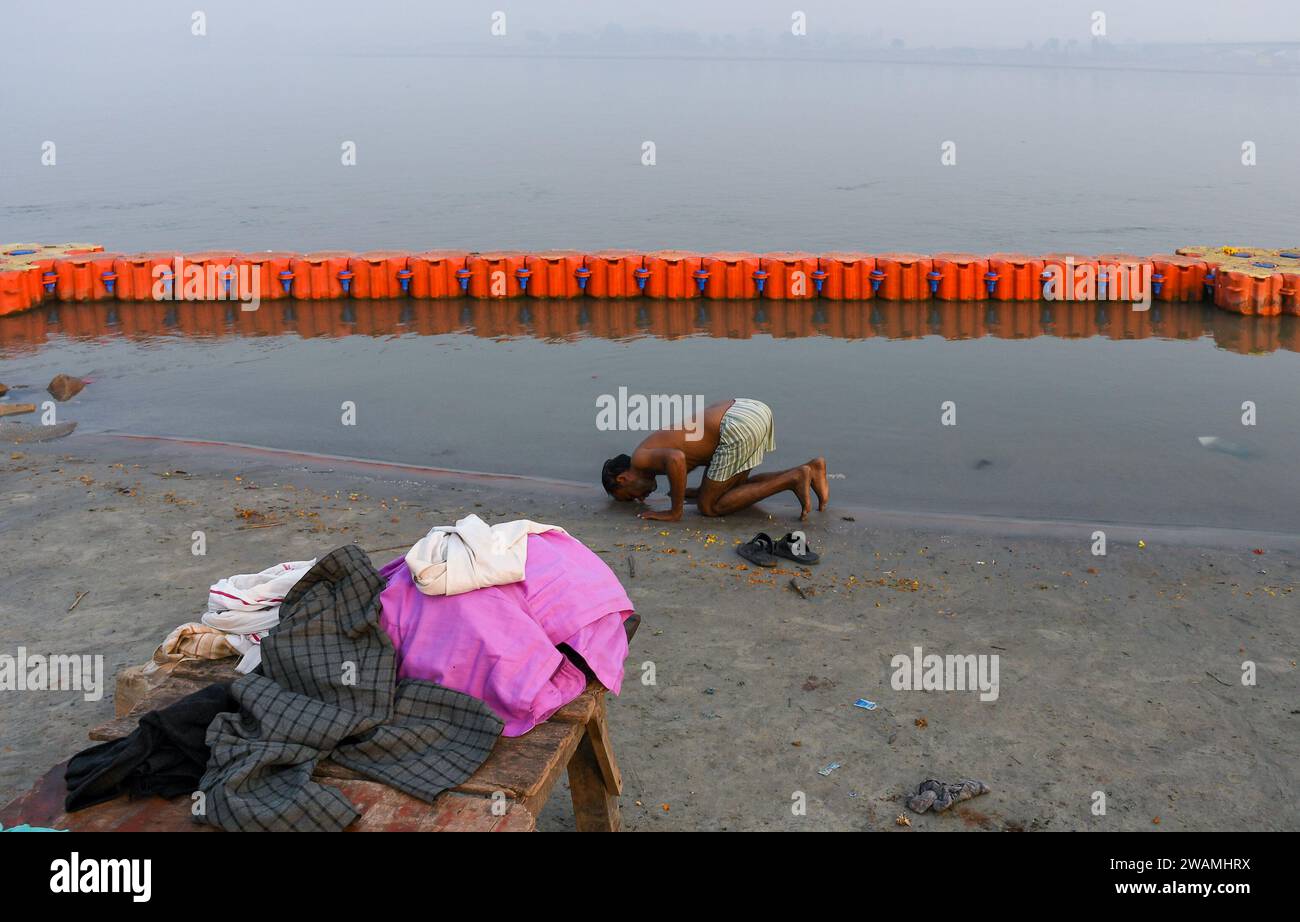 A Hindu devotee offers his prayers on the banks of Saryu river. The ...