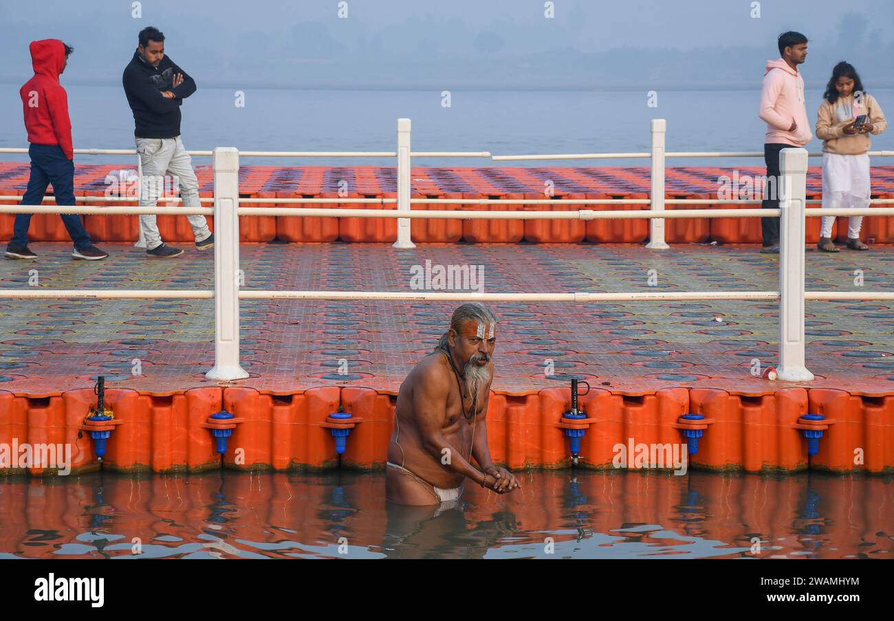 A Hindu devotee reacts to the camera as he takes a dip in the river ...
