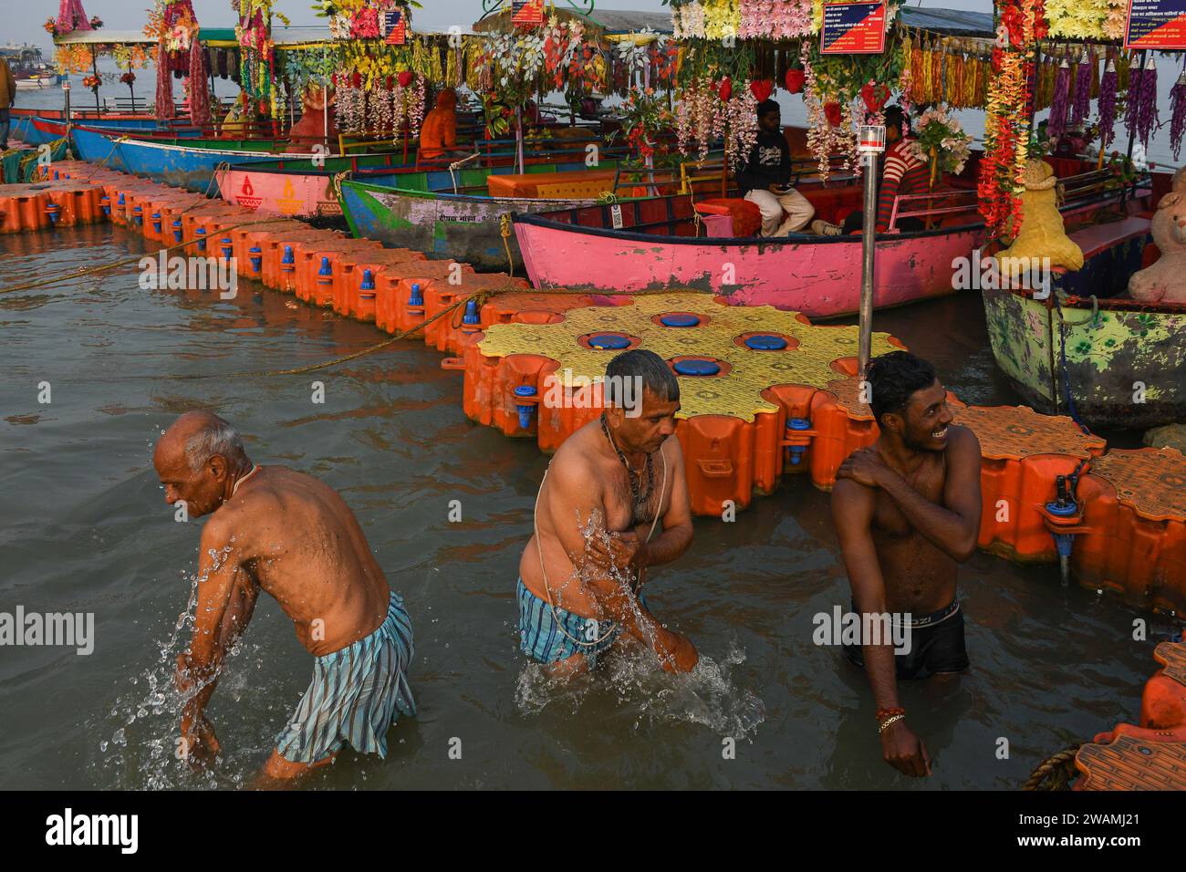 Devotees take a dip in the river Sarayu as part of their Hindu ritual ...