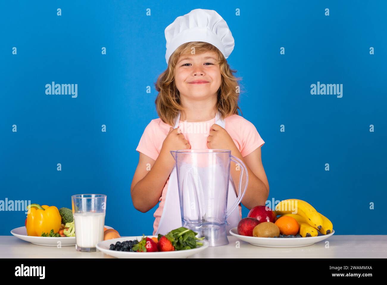 Cooking children. Chef kid boy making fresh vegetables for healthy eat ...