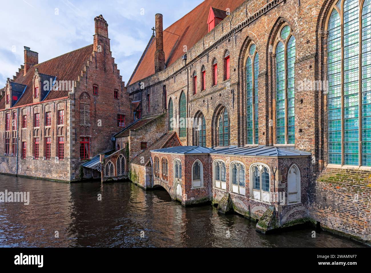Traditional medieval canal architecture with brick walls, Bruges ...