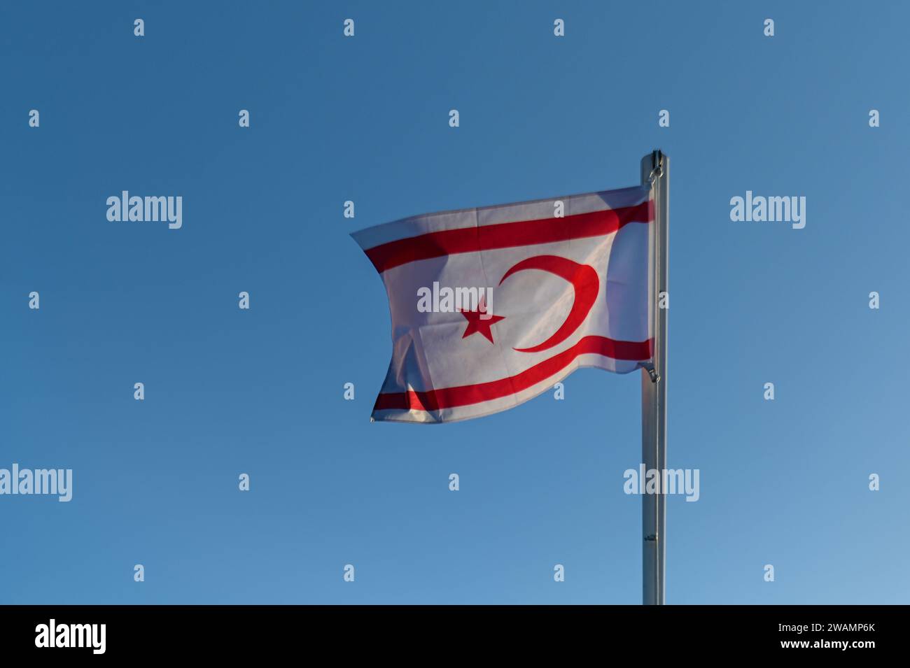 flag of the Turkish Republic of Northern Cyprus against the blue sky ...