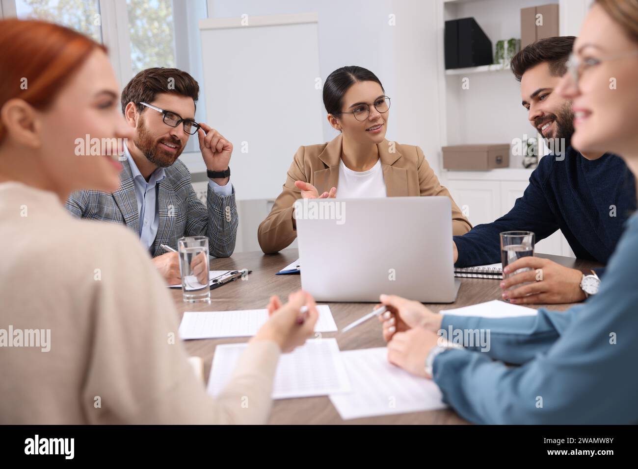 Team of employees working together in office Stock Photo - Alamy