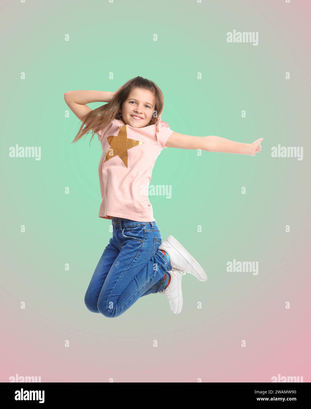 Happy cute girl jumping on color gradient background Stock Photo - Alamy