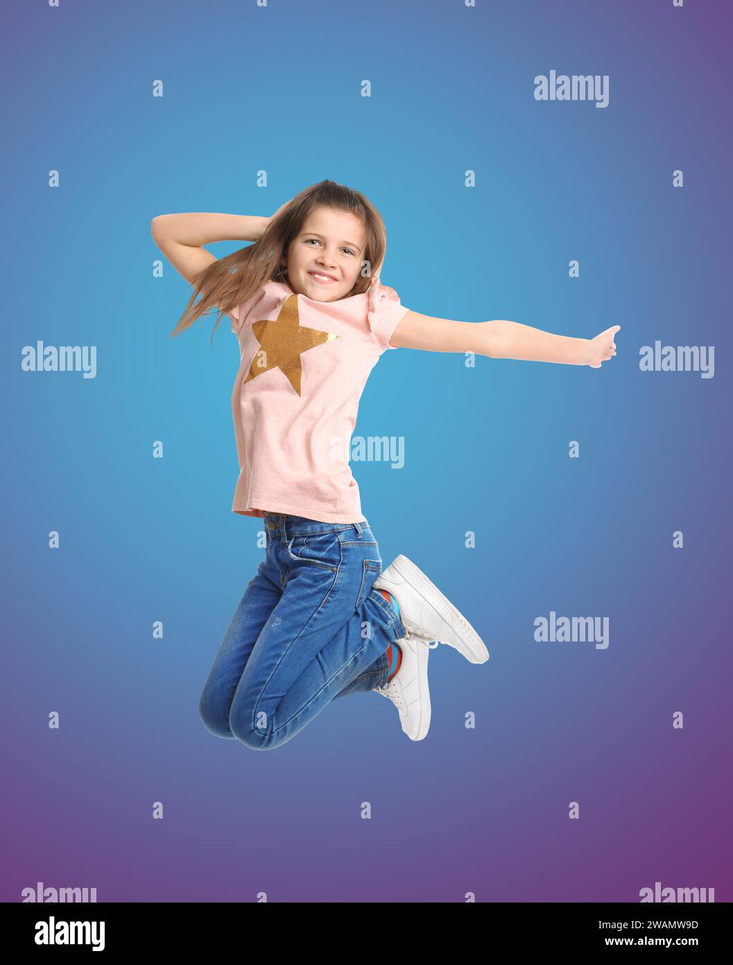 Happy cute girl jumping on color gradient background Stock Photo - Alamy