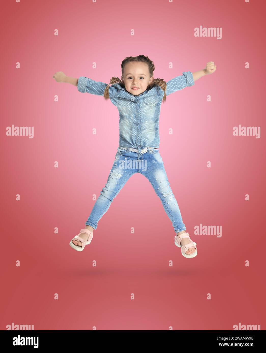 Happy cute girl jumping on color gradient background Stock Photo - Alamy