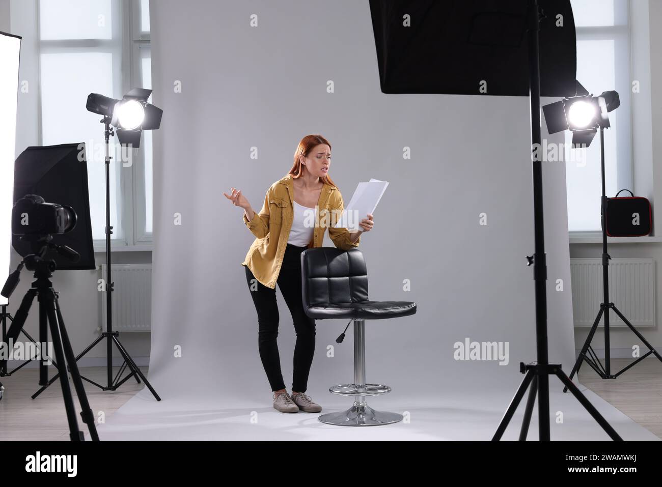 Casting call. Emotional woman with script performing on grey background ...