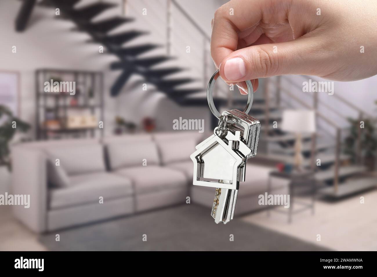 Woman holding house keys hi-res stock photography and images - Alamy