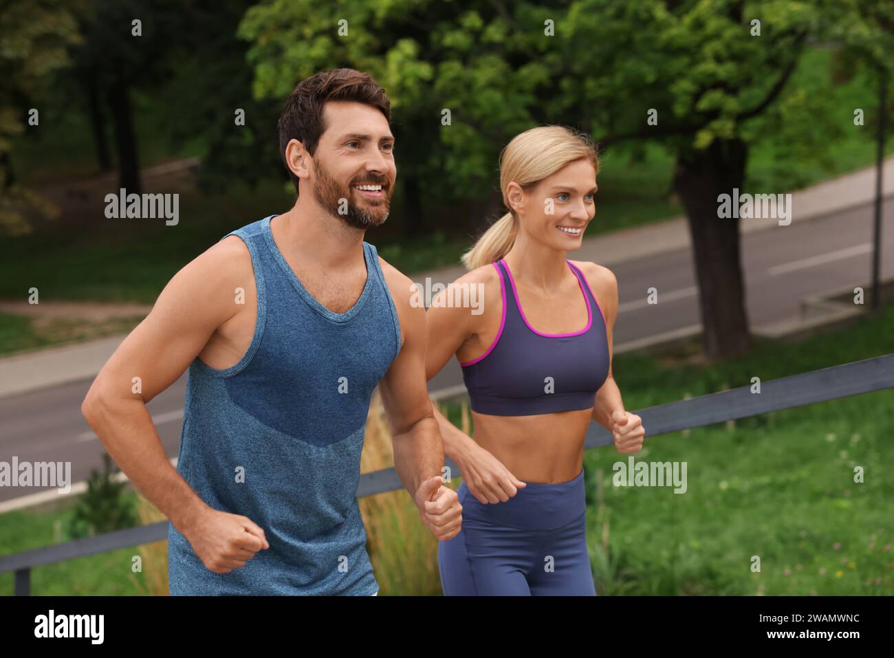 Healthy lifestyle. Happy couple running in park Stock Photo - Alamy