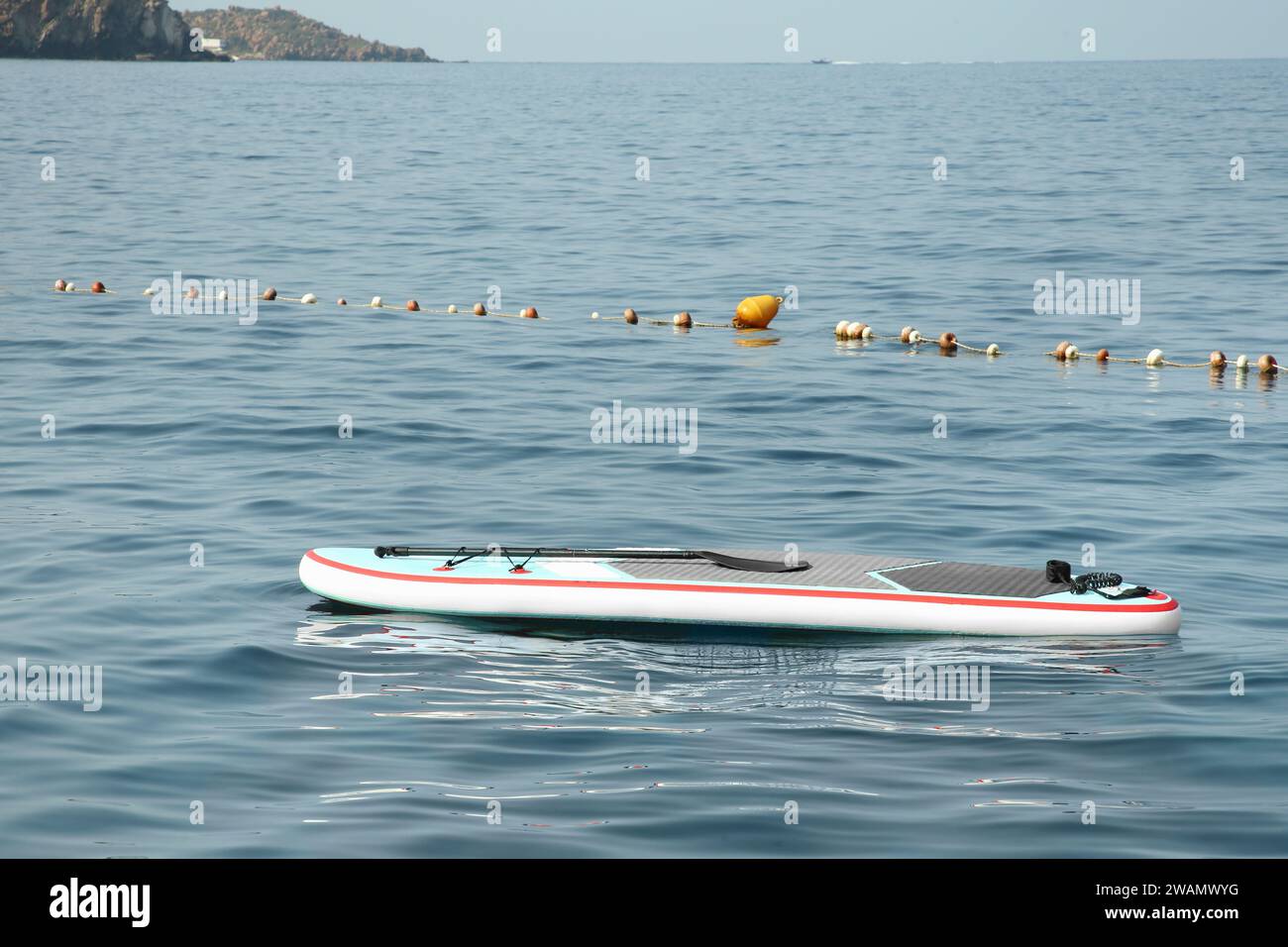 One SUP board with paddle on water in sea Stock Photo - Alamy